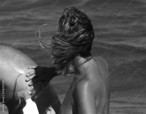 Side View Of Naked Woman Applying Sun Screen On Man At Beach Foto De Stock Adobe Stock