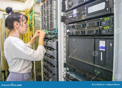 The Girl Commutes The Wires Of Powerful Internet Routers A Woman Switches The Cable In The