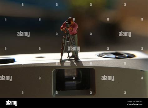 Miniature Figure Of A Videographer Recording On An Analog Camera Stock