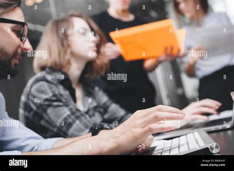 Bearded Young Business Man Typing Text On Modern Keyboard Teamwork In Loft Space Business