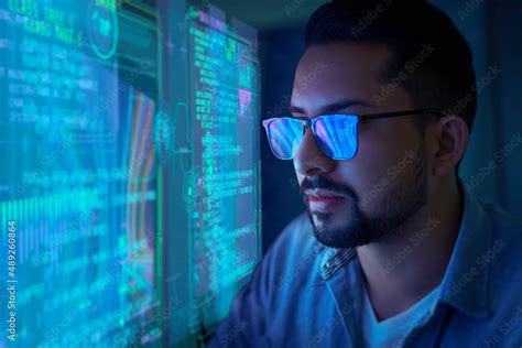 Portrait Of Software Developer Hacker Wearing Glasses Sitting At His Desk And Working On