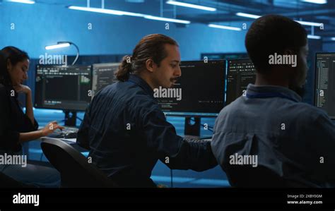 Multiracial Coworkers In Data Center Coding And Checking Parameters On