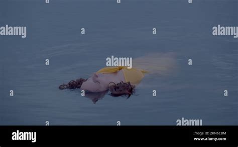 Sexual Female Floating On Water Wearing Yellow Dress Back View Stock Video Footage Alamy