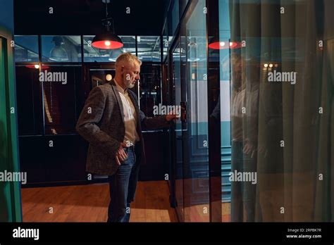 Businessman Enters Password Lock Code On Alarm Panel In Office Door For