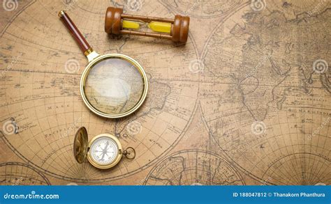 Old Compass Magnifying Glass And Sand Clock On Vintage Map Stock