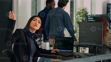 Asian Coder Turning Head To Work With Holographic Server Code Typing
