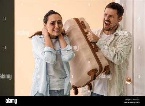 Angry Husband Kicking His Wife With Suitcase Out Near Door Domestic