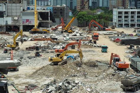 many excavators working on the ground of the construction site while