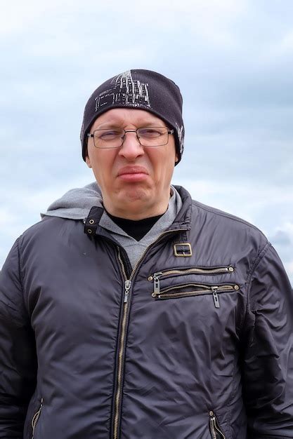 Premium Photo Man With A Dissatisfied Face Standing On The Road