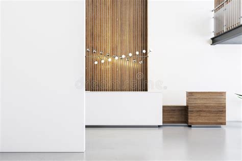 An Empty Reception Area With A White Counter Wooden Feature Wall And Modern Lighting On A
