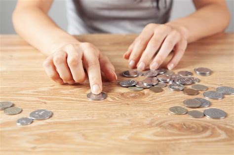 Premium Photo Woman Counting Coins On The Table