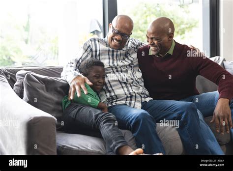 Happy African American Father Son And Grandfather Sitting On Couch