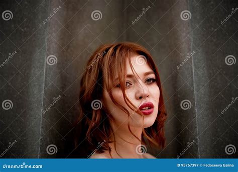 Portrait Of A Beautiful Redhead Fiery Hair And Full Lips Walking Around The City Stock Image