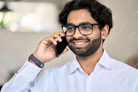 Premium Photo Smiling Young Indian Business Man Talking On Phone