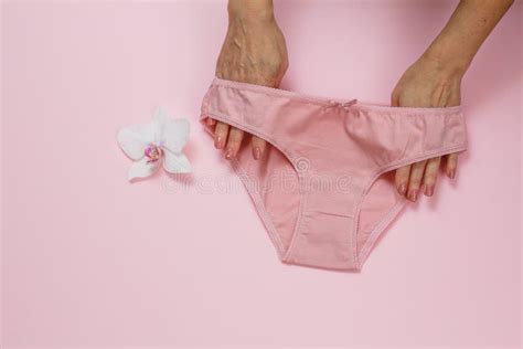 Womenand X27s Hands With Beautiful Panties On Pink Background Stock