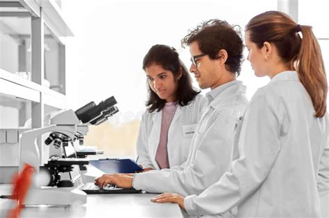 Scientists With Microscopes Working In Laboratory Stock Image Image Of Analyzing Biochemistry