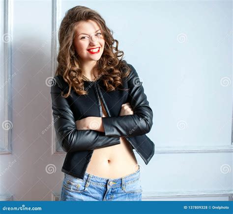 Beautiful Woman In Black Jacket Wearing On Naked Body Posing Near The Wall Stock Photo Image