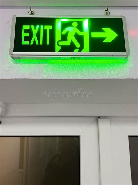 Illuminated Green Exit Sign Above A Door Indicating A Safe Evacuation Route Stock Image Image