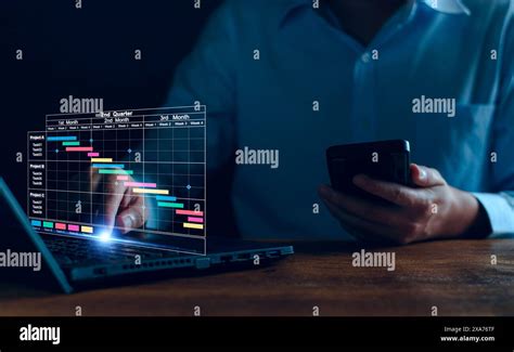 Project Manager Working On Tablet Updating Tasks And Milestones
