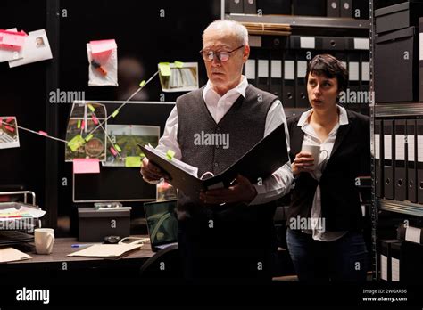 Private Detectives Working At Criminal Case Analyzing Crime Scene Evidence In Arhive Room