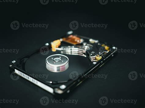 Disassembled Open Hard Disk Drive HDD Of Computer Or Laptop Lies On Dark Matte Surface 25801300