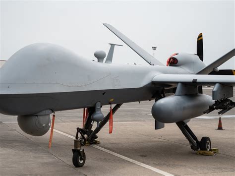 Predator Drone Next To Plane