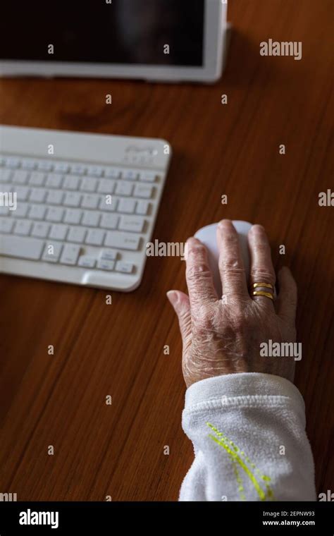 Crop Anonymous Patient With Keyboard Against Tablet With Doctor On Screen During Video Call In
