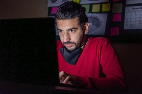 Premium Photo Young Male Working During Night Overtime Coding Alone And Feeling Cold During