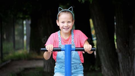 Smiling Happy Eight Year Old Girl In Swimsuit Having Fun In Splashes