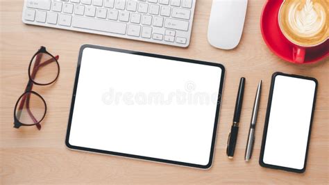 Office Wooden Desk Workplace With Blank Sceen Tablet And Smartphone