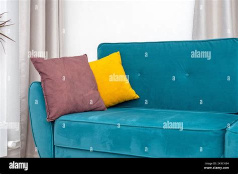 Bright Yellow Pillow On Blue Turquoise Sofa Or Couch Interior Of The
