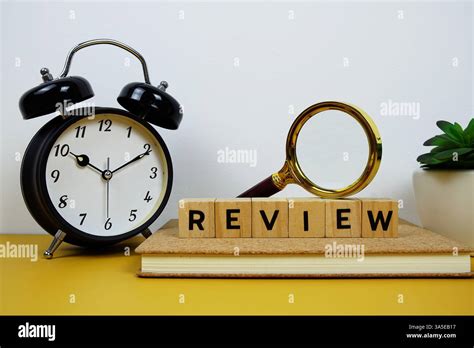 Magnifying Glass And Alarm Clock With Wooden Blocks Alphabet Letters Review Text Message On