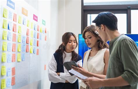 Brainstorming Session Using Sticky Notes On A Task Board Kanban To Organize Ideas And