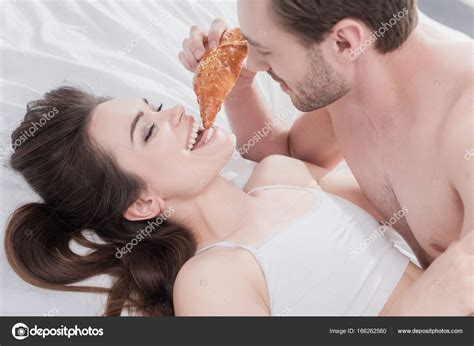 Man Feeding His Girlfriend In Bed Stock Photo Dmitrypoch