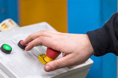 Hand Pressing The Red Emergency Button Or Stop Button For Industrial