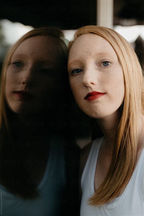 Moody Reflected Headshot Of Redhead Teen By Stocksy Contributor