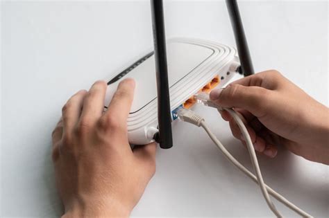 Premium Photo Hand Conncecting The Ethernet Wire Cable With Wi Fi