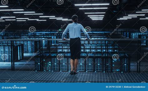 Data Center Engineer Looking Down From A Balcony On Server Farm Cloud Computing Specialist