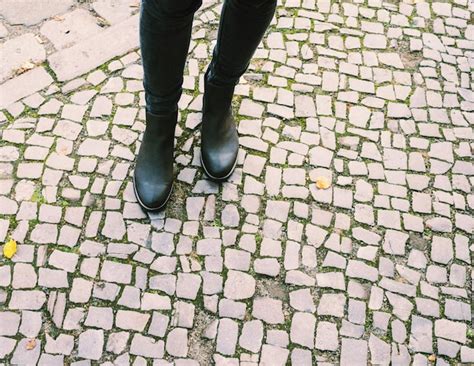Premium Photo Low Section Of Woman Standing On Cobblestone Footpath