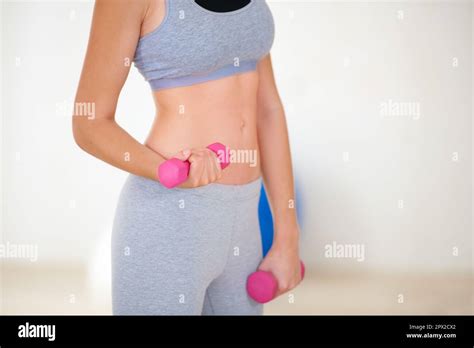 Bicep Curls Cropped Image Of A Young Woman Training With Weights Stock