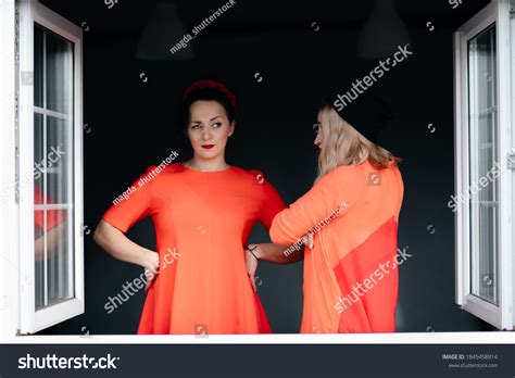 Two Girls Red Dresses Pose By Stock Photo Shutterstock