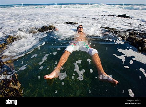 Man Floating In The Sea In A Rock Pool With Waves In The Ocean Stock Photo Alamy
