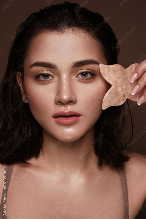 Beautiful Young Girl With Natural Nude Make Up With Gua Sha For Facial