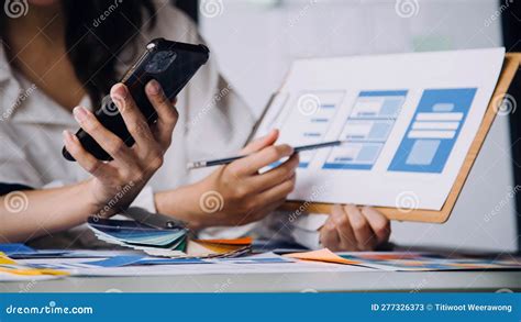 Close Up Ux Developer And Ui Designer Brainstorming About Mobile App