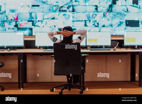Female Security Operator Working In A Data System Control Room Offices Technical Operator