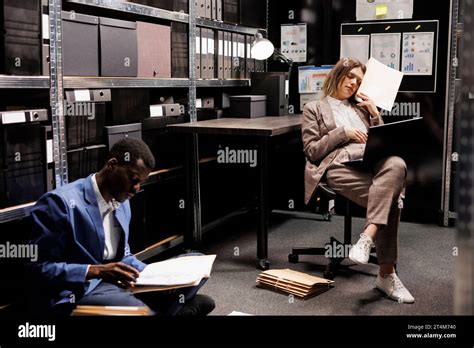 Tired Diverse Inspectors Working Overhours In Police Station Analyzing