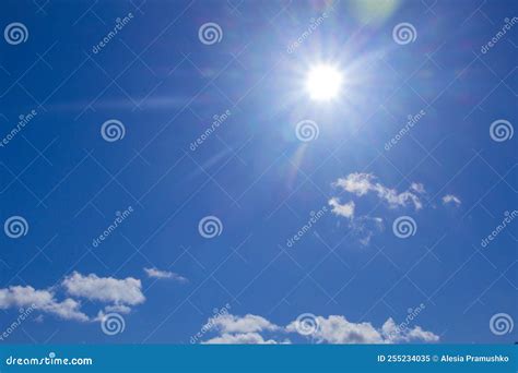 Landscape Of A Bright Blue Summer Sky With A White Sun And Clouds In