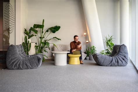 Premium Photo Male Computer Programmer Using Mobile Phone And Laptop While Working Comfortably