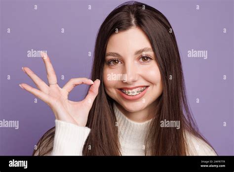 Portrait Of A Girl With Braces Woman Happy With Braces Shows Ok Sign Stock Photo Alamy