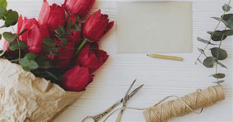 행복한 어머니의 날 인사말 카드 선물 연필 가위 소박한 흰색 나무 배경에 꼬기가 있는 공예 종이에 아름다운 빨간 튤립 행복한 여성의 날 인사말 카드 템플릿 사진